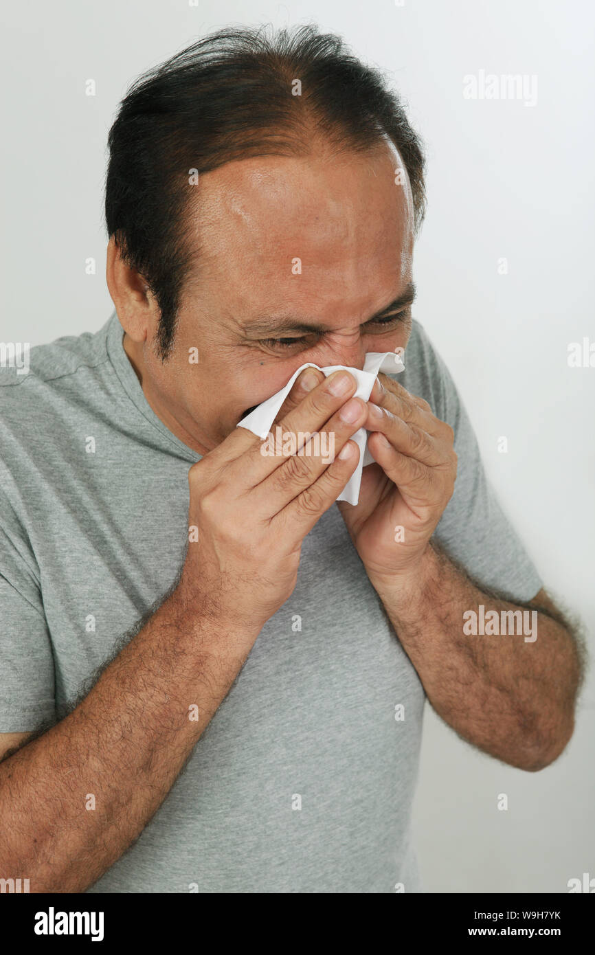 Mature man blowing nose hi-res stock photography and images - Alamy