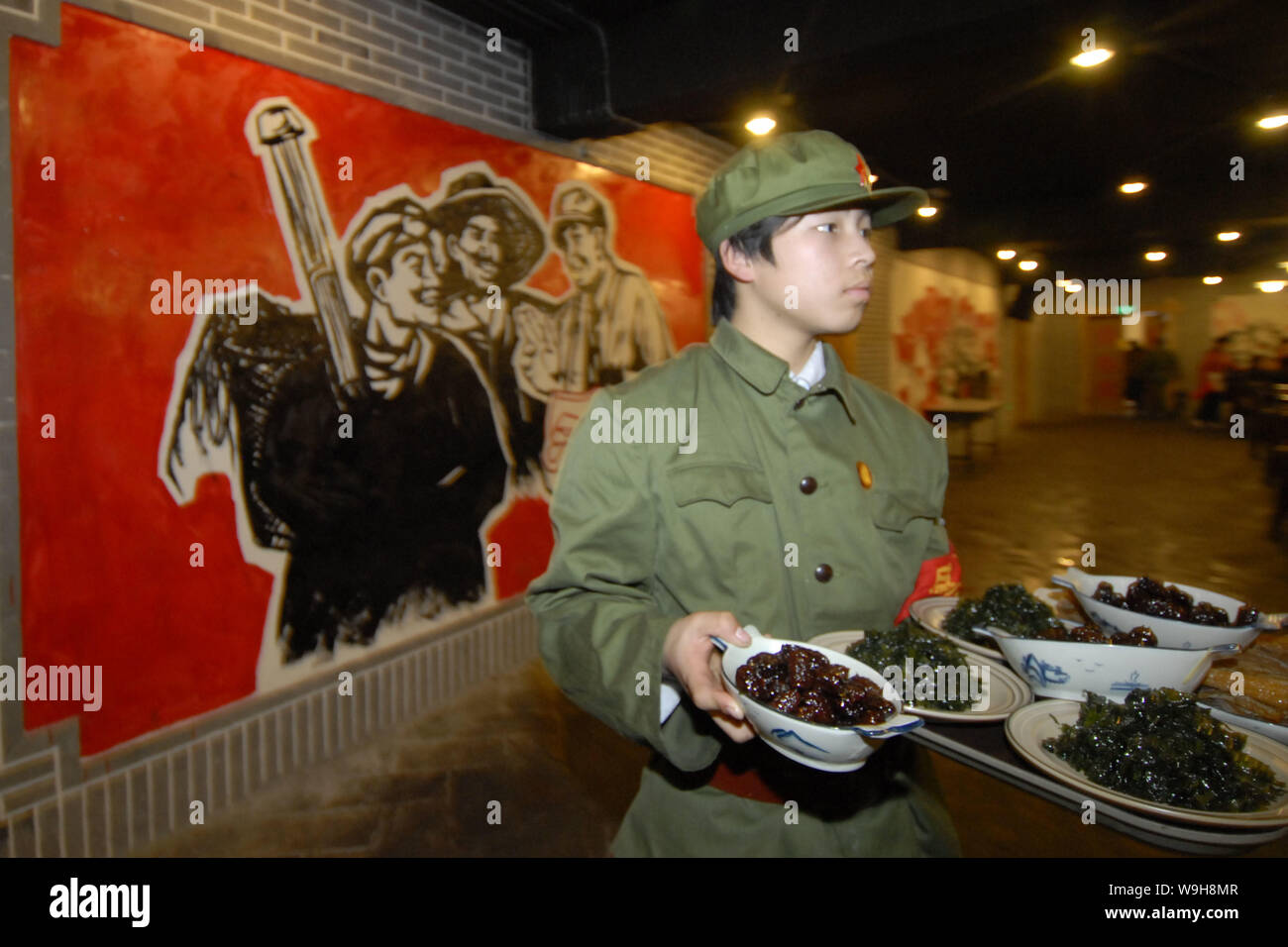 A Chinese waiter dressed like a red guard of the Cultural Revolution ...