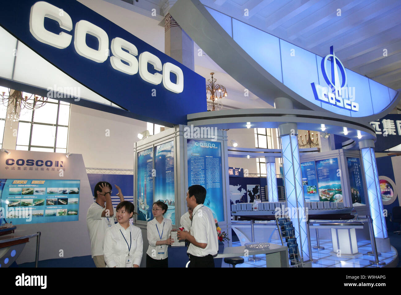 Chinese employees at the stand of China Overseas Shipping (Group) Co ...