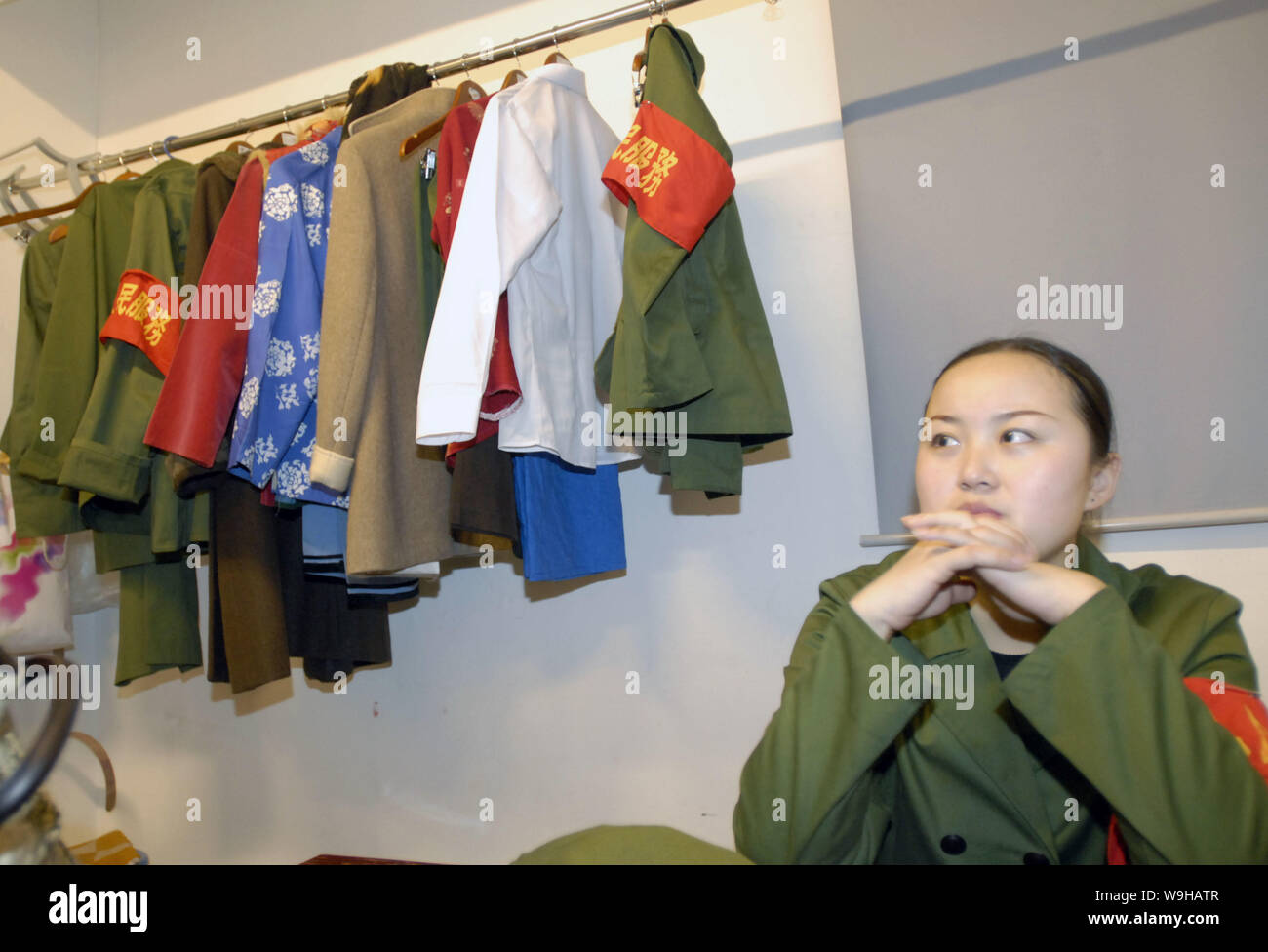 A Chinese waitress dressed like a red guard of the Cultural Revolution ...