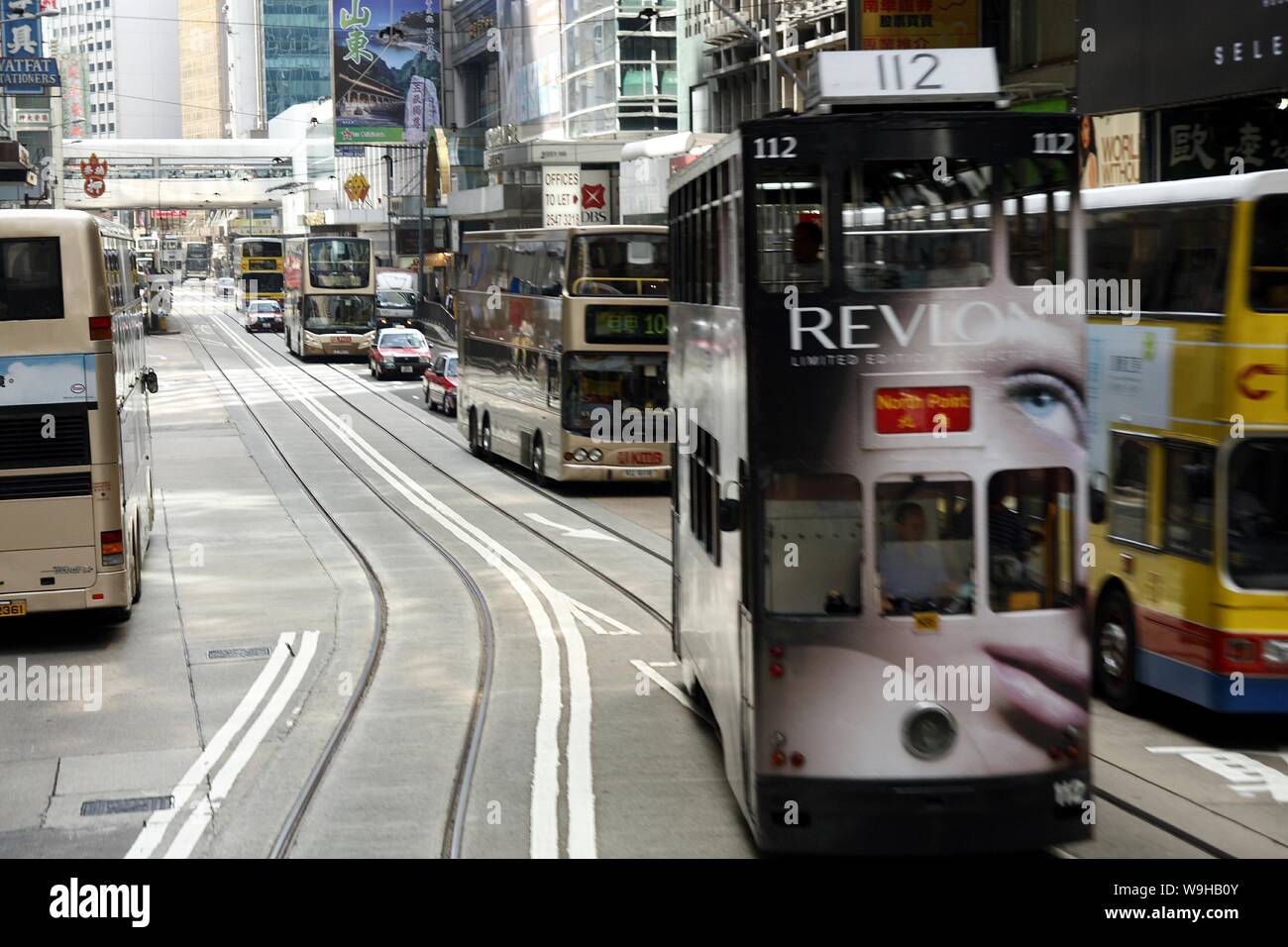 Double-decker trams, buses and cars are seen on the street in Causeway ...