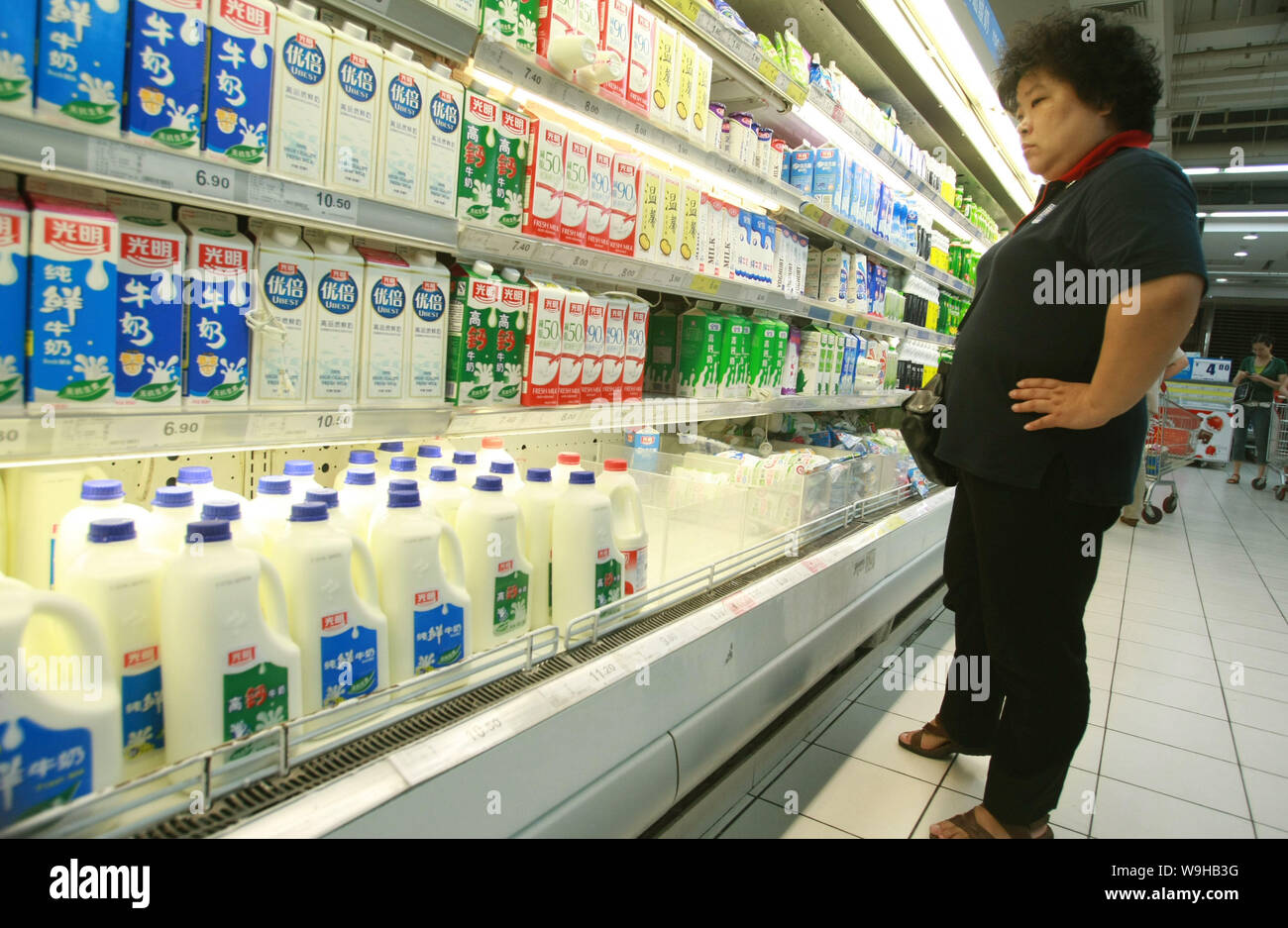 A customer shopping for milk at a supermarket in Shanghai 1 August 2007 ...