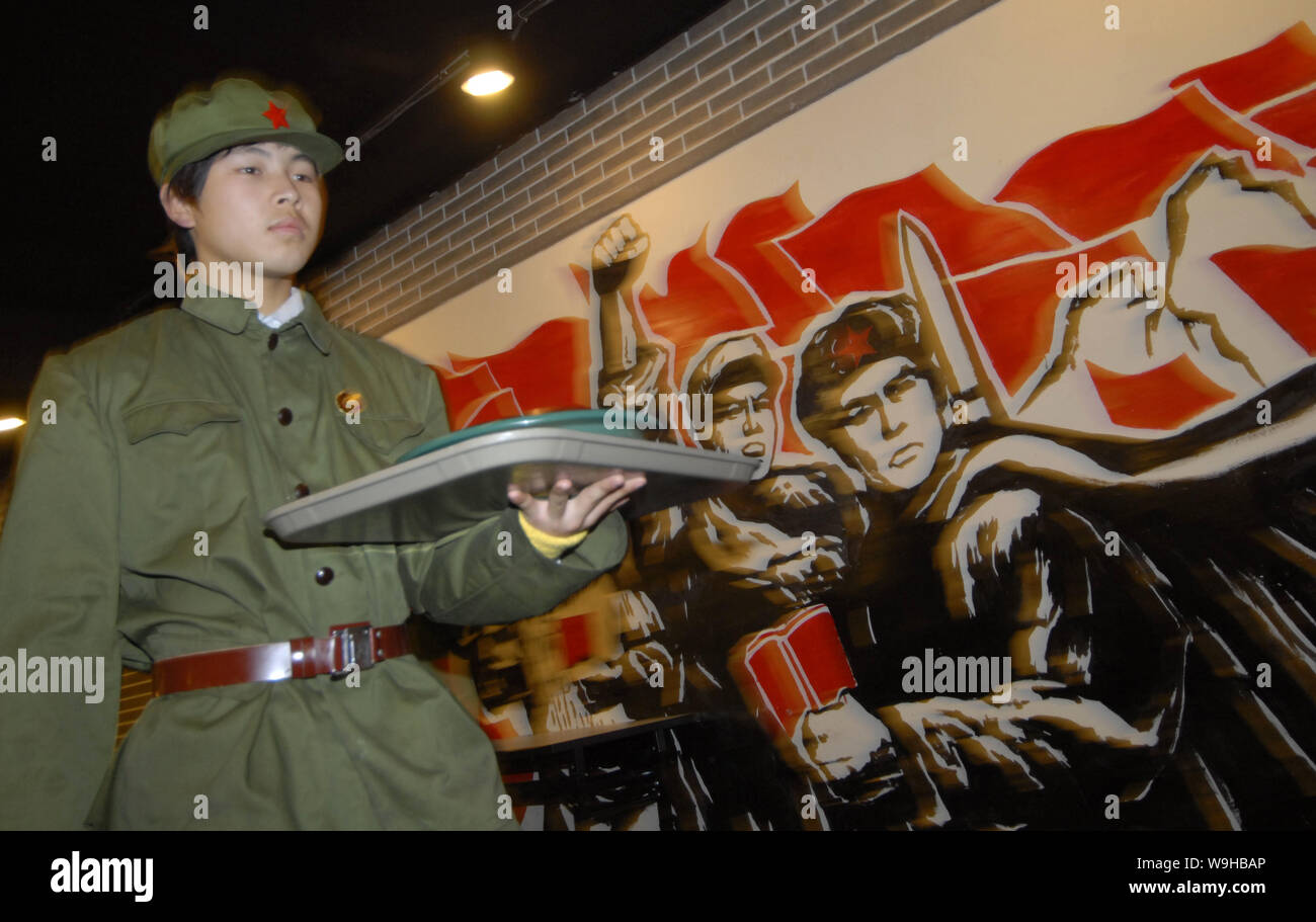 A Chinese waiter dressed like a red guard of the Cultural Revolution ...