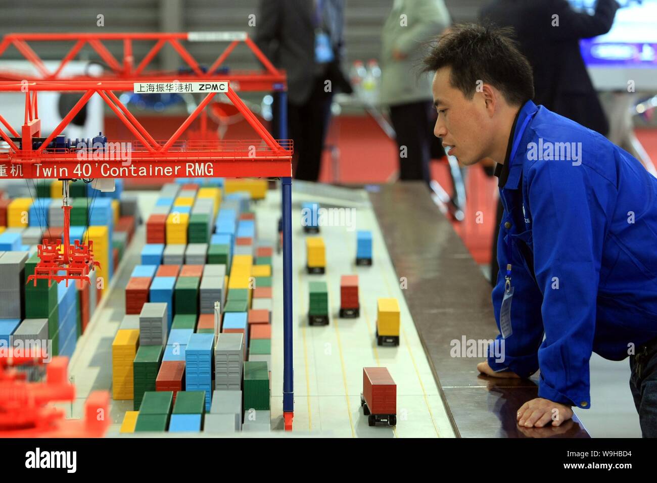 A visitor looks at model container crane of ZPMC (Zhenhua Port ...