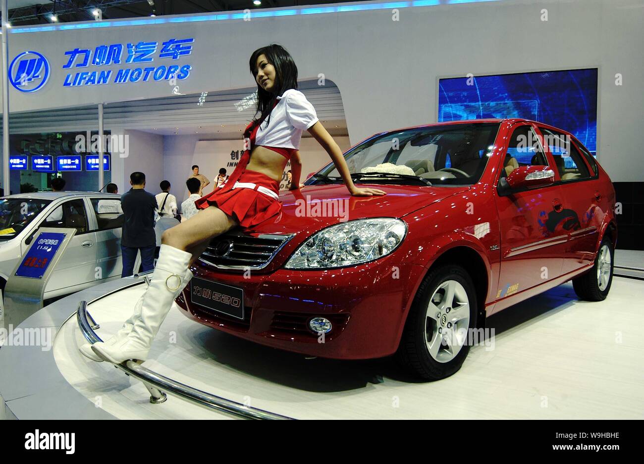A model poses by a Lifan car during an exhibition in Chengdu, southwest ...