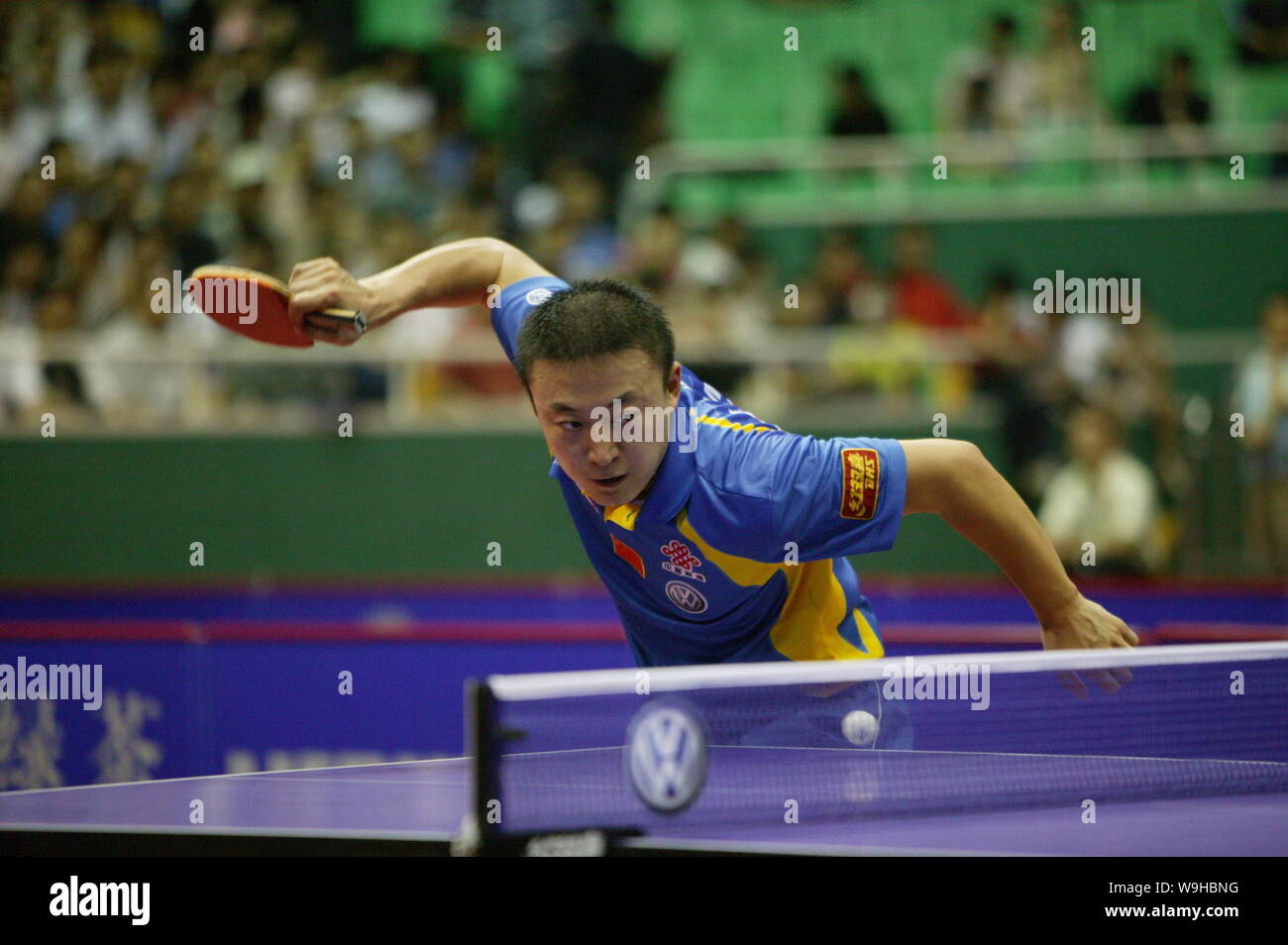 Chinas Ma Lin competes with Wang Hao (unseen) during the final of the ...