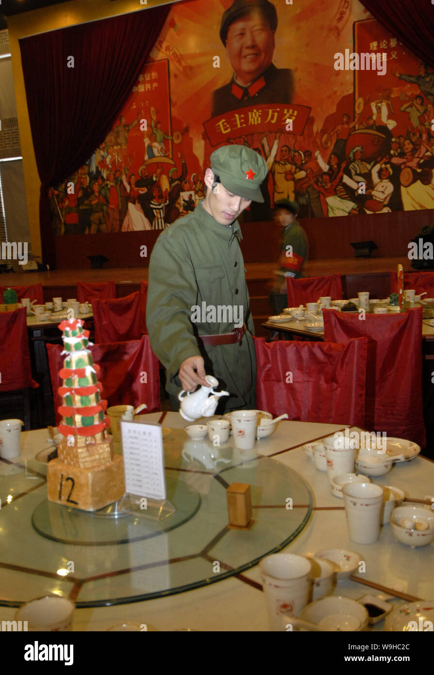 A Chinese waiter dressed like a red guard of the Cultural Revolution ...