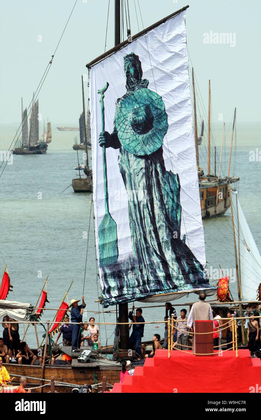Local Chinese fishermen raise a sail with portrait of Da Yu, an ...