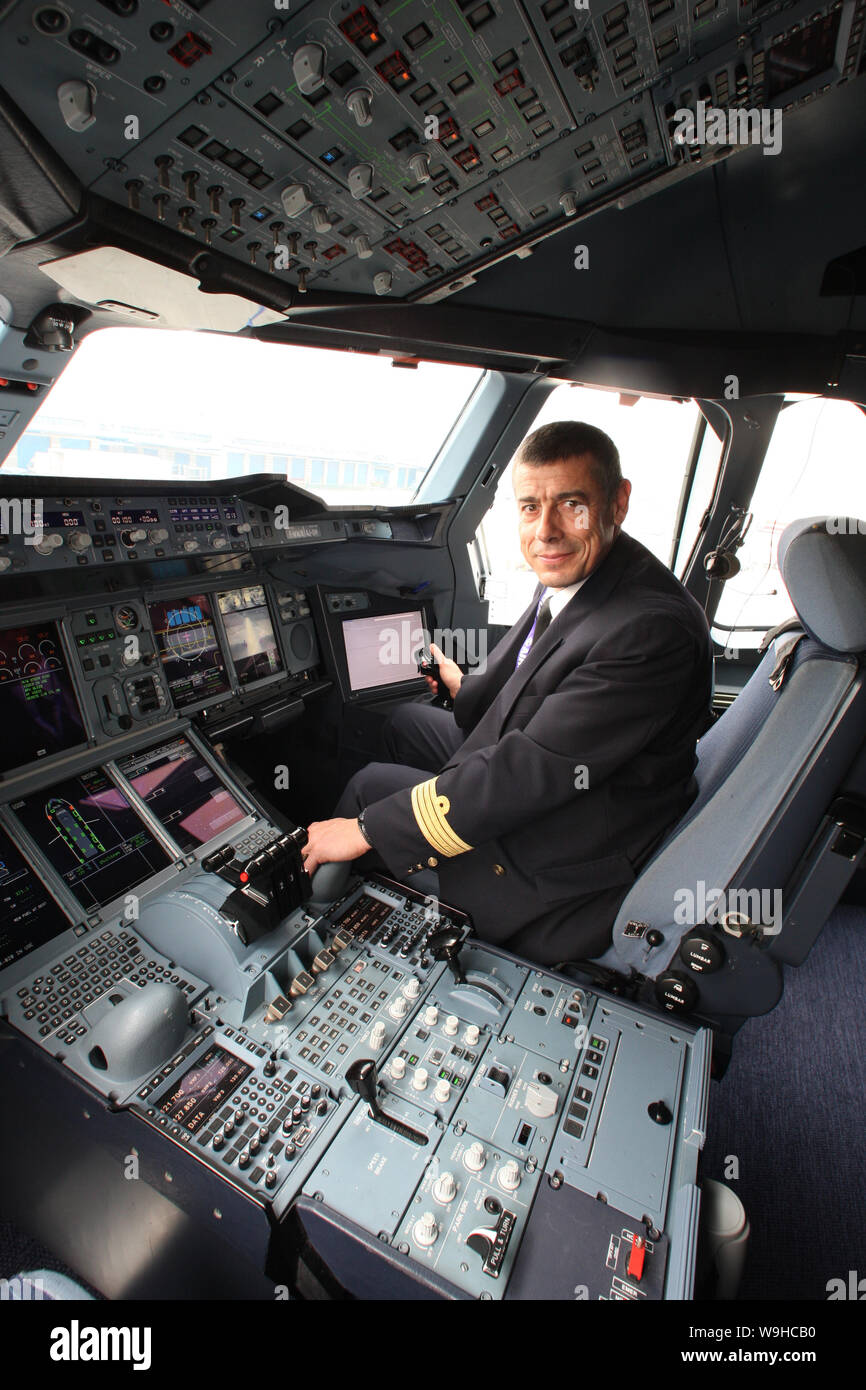 Test pilot Jean Michel Roy sits at the cockpit of the Airbus A380 ...