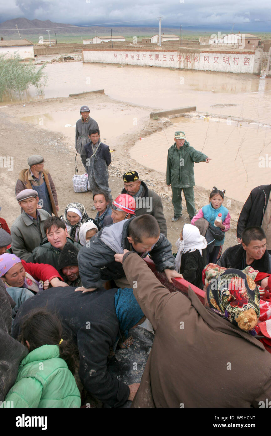Local residents are evacuated from flooded areas in Barkol Kazak ...