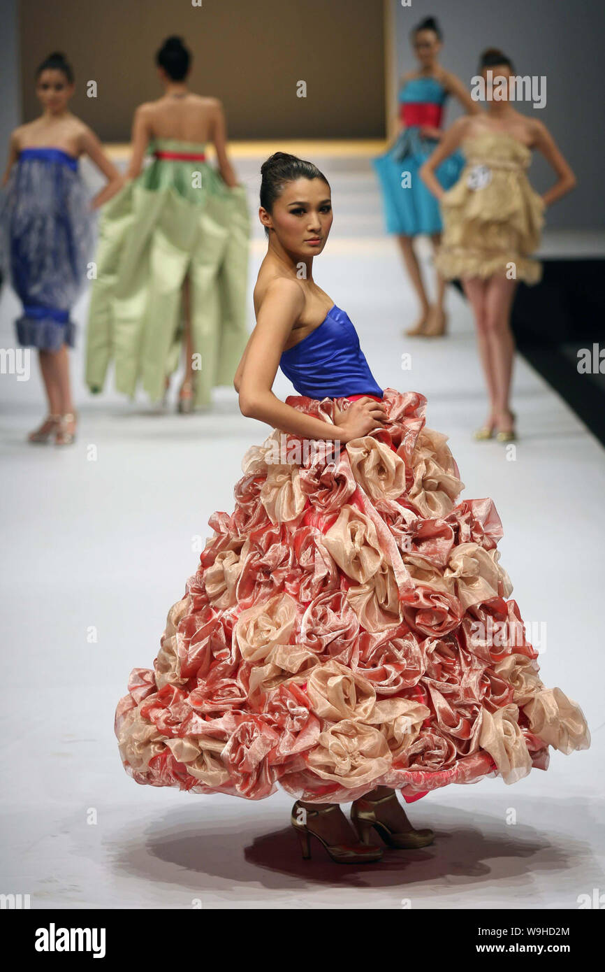 Models parade a fashion design by a young designer during a contest to ...