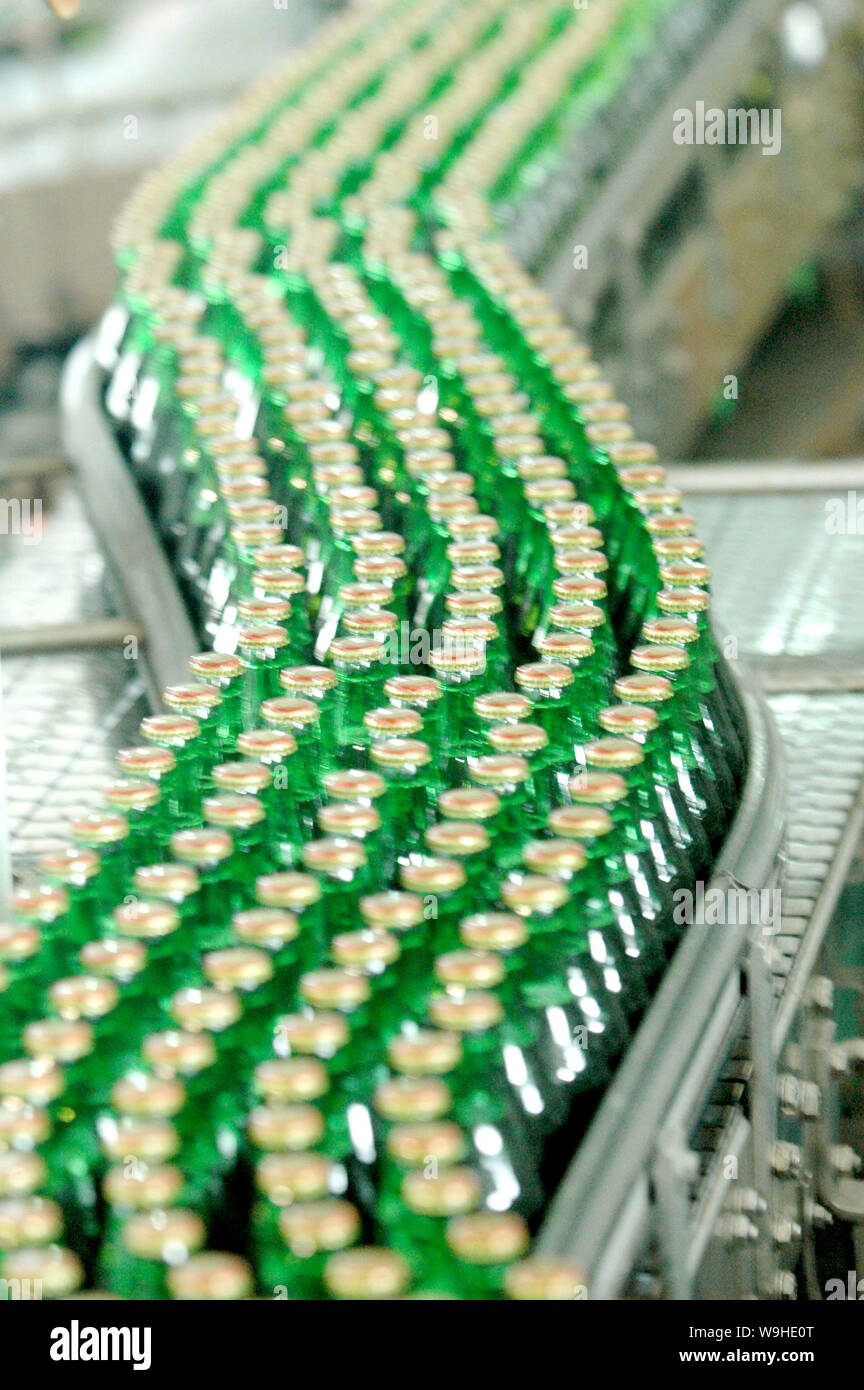 Beer bottles on the production line at TsingTao Brewery in Qingdao ...