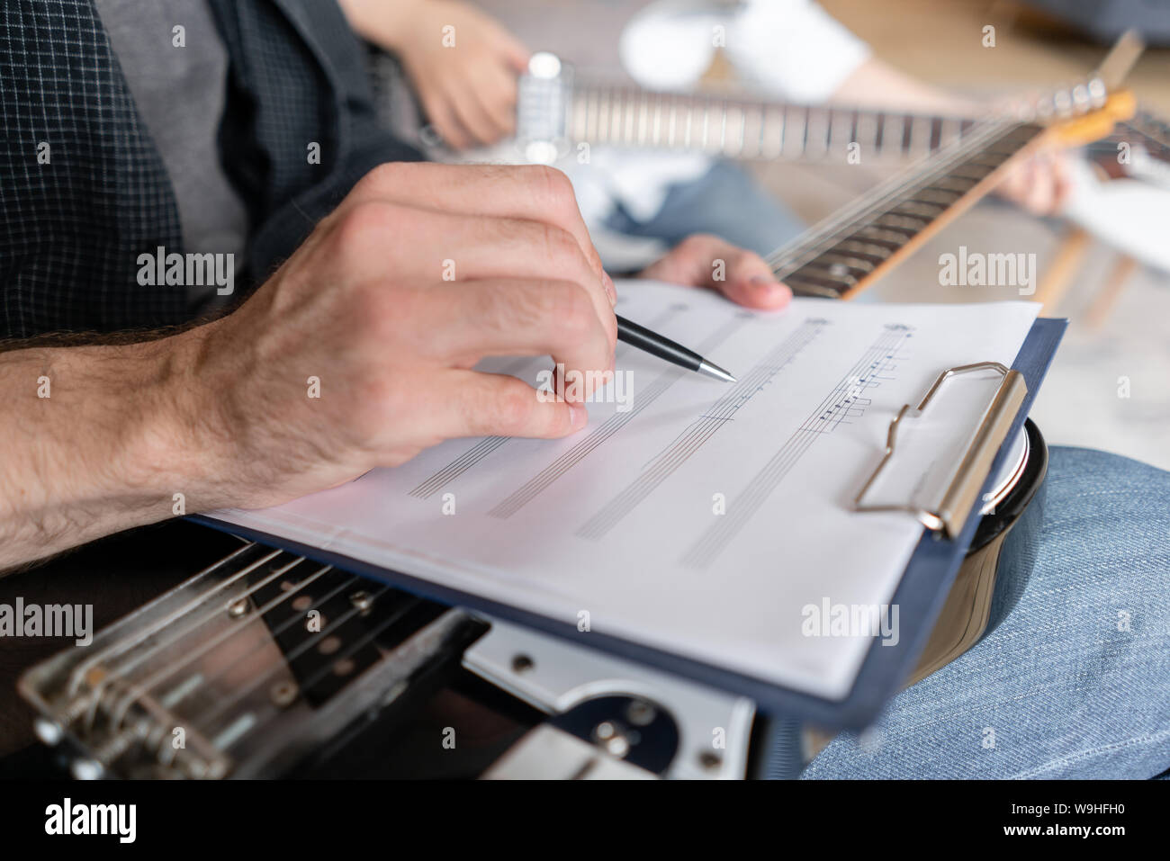 Older brother explains to his younger one how to use notes on music ...