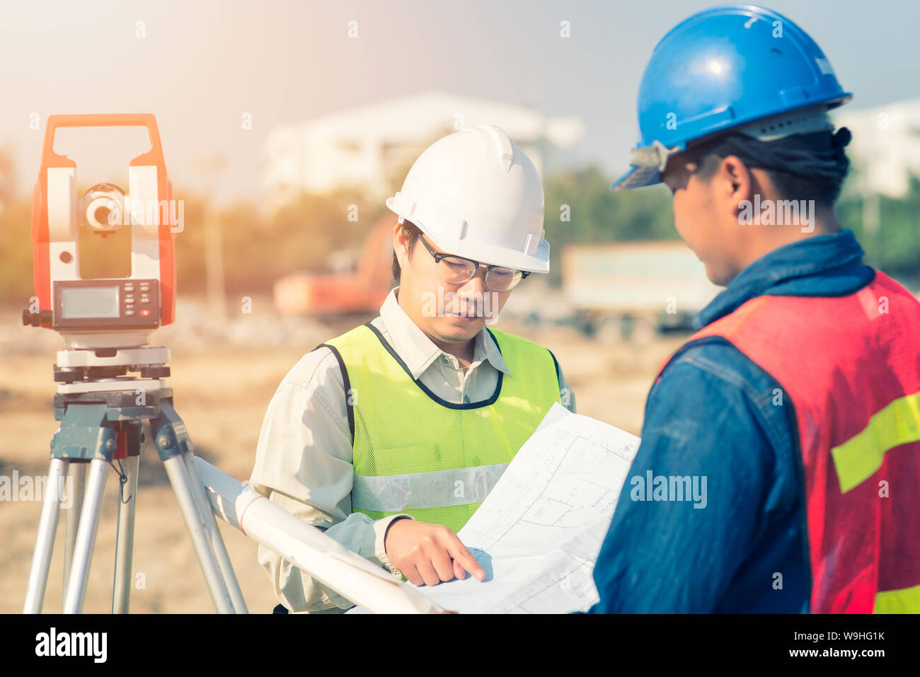 Construction engineer with foreman worker checking construction drawing ...