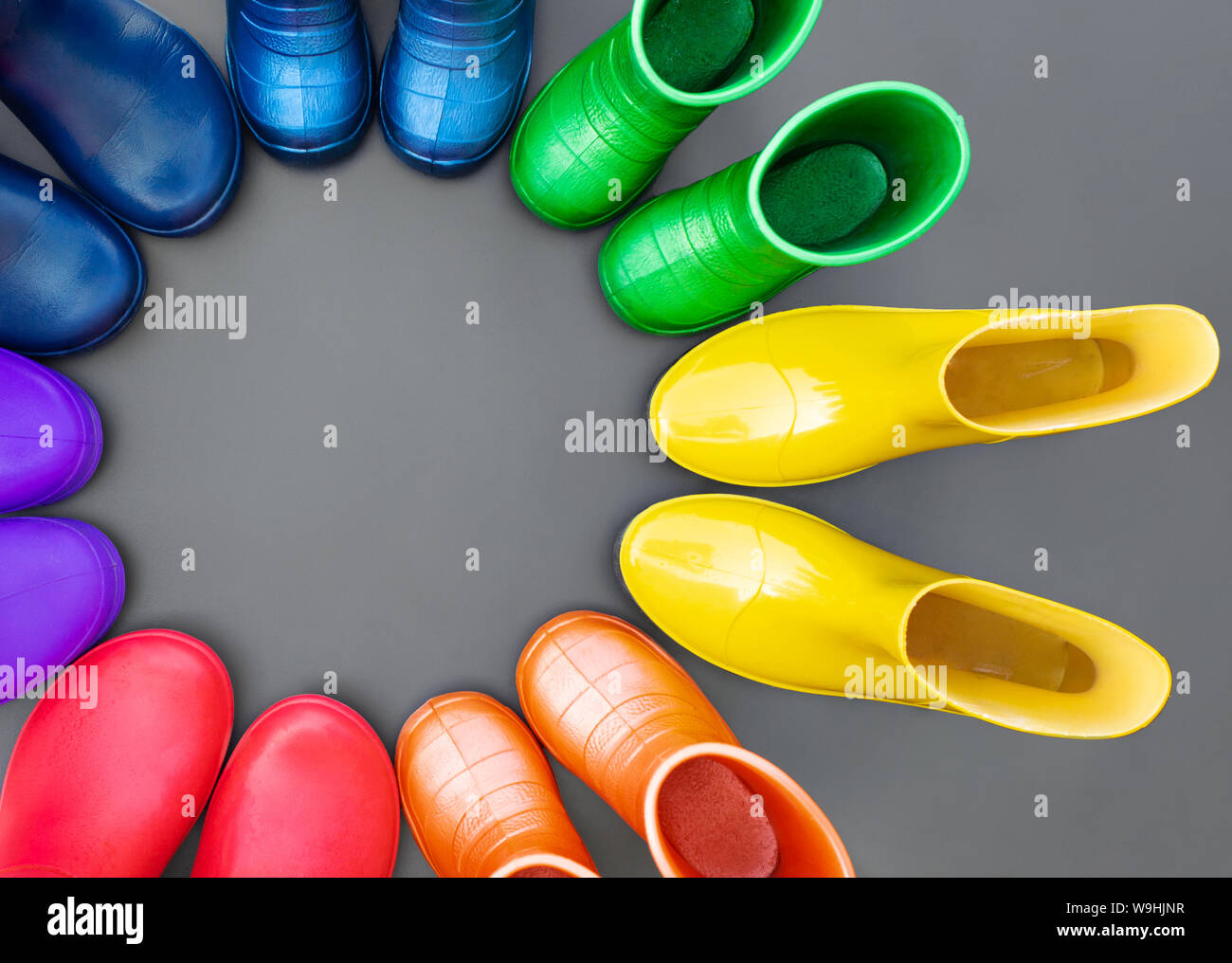 Colorful rubber boots of all colors of the rainbow-red, orange, yellow ...