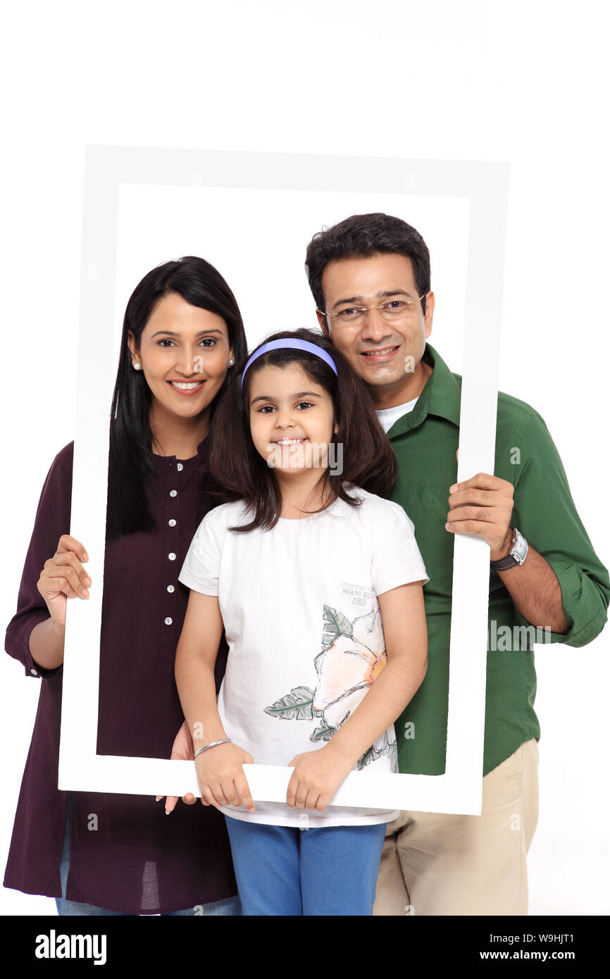 Family looking through empty frame Stock Photo - Alamy