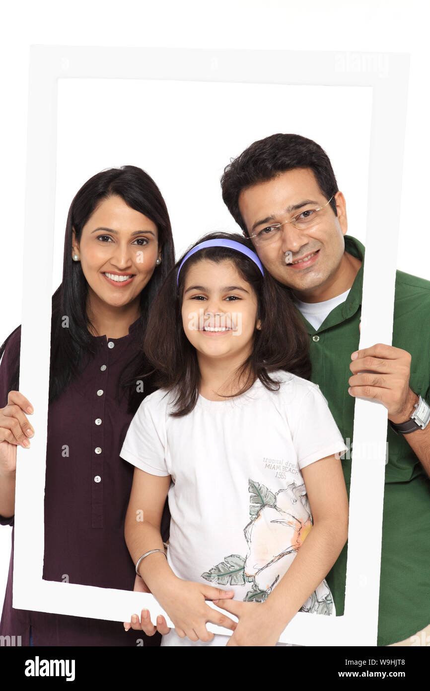 Family looking through empty frame Stock Photo - Alamy
