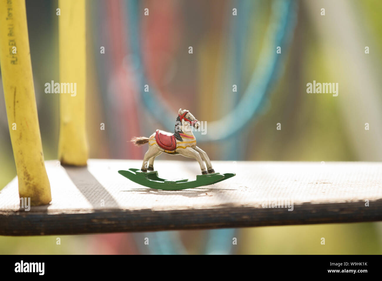 wooden antique miniature rocking horse at a colorful playground with ...
