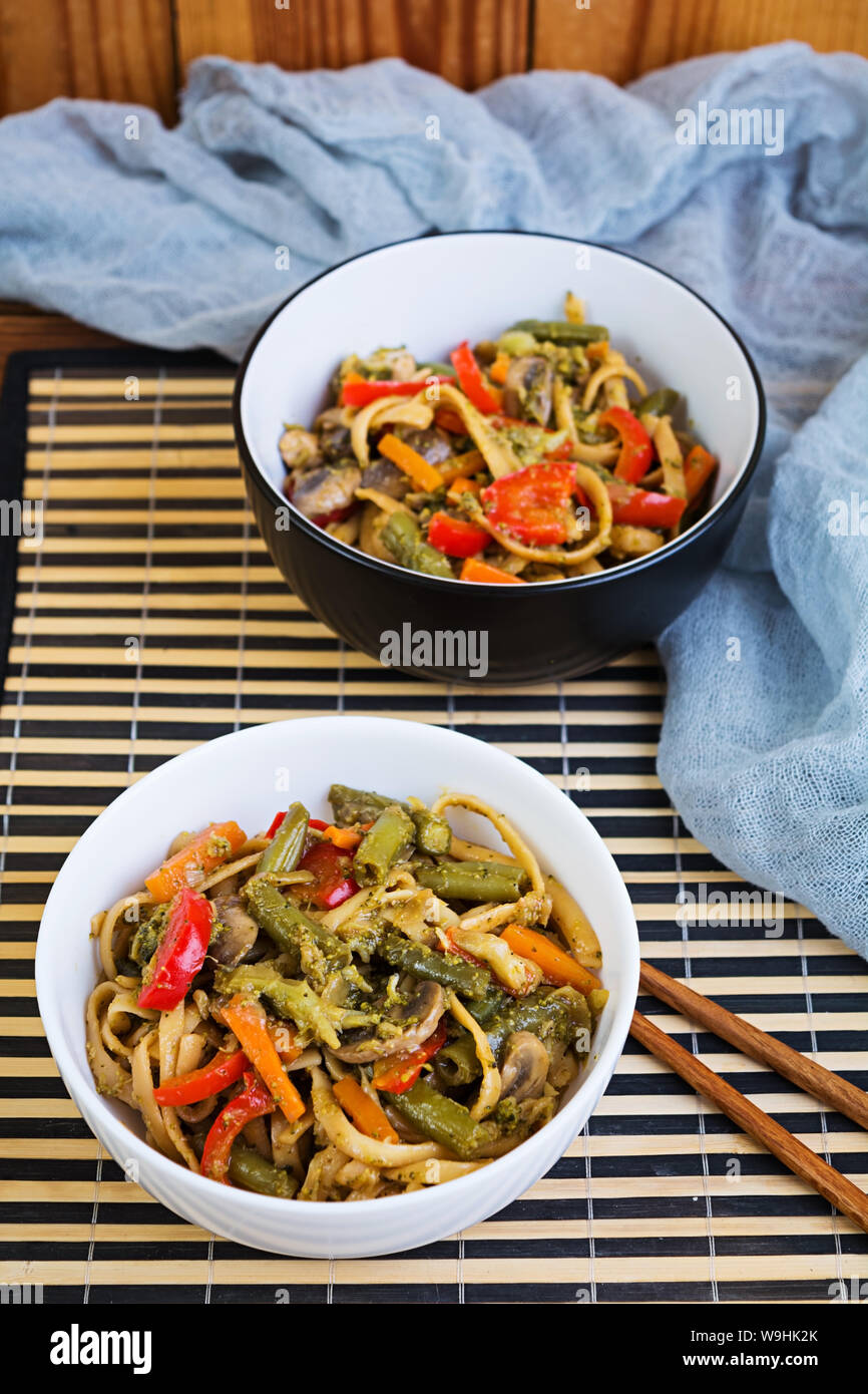 Vegetable stir fry with noodles on wooden background Stock Photo - Alamy