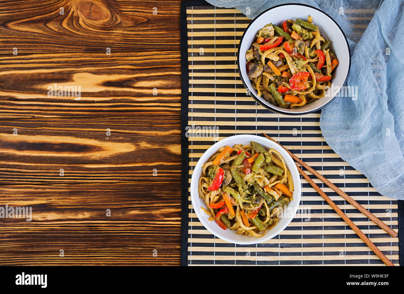 Vegetable stir fry with noodles on wooden background Stock Photo - Alamy