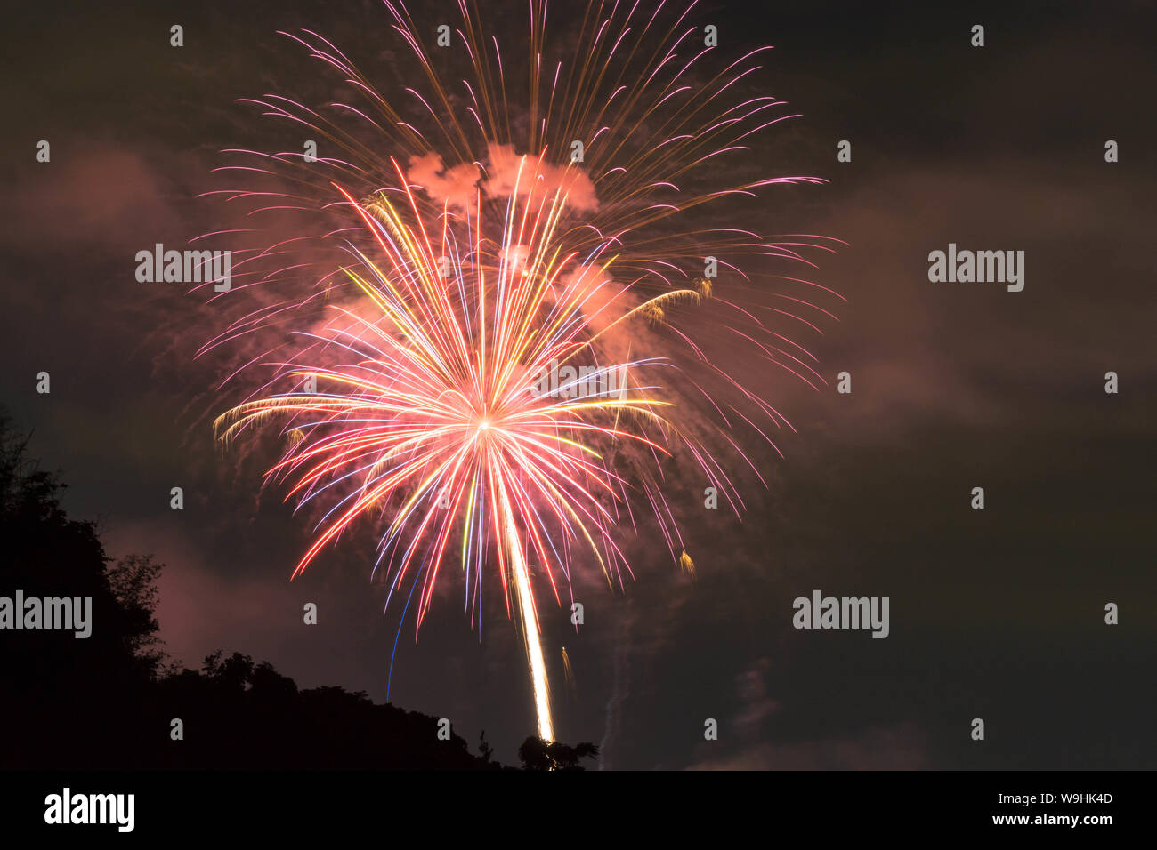 Beautiful fireworks display in the air with smokes. Summer time in ...