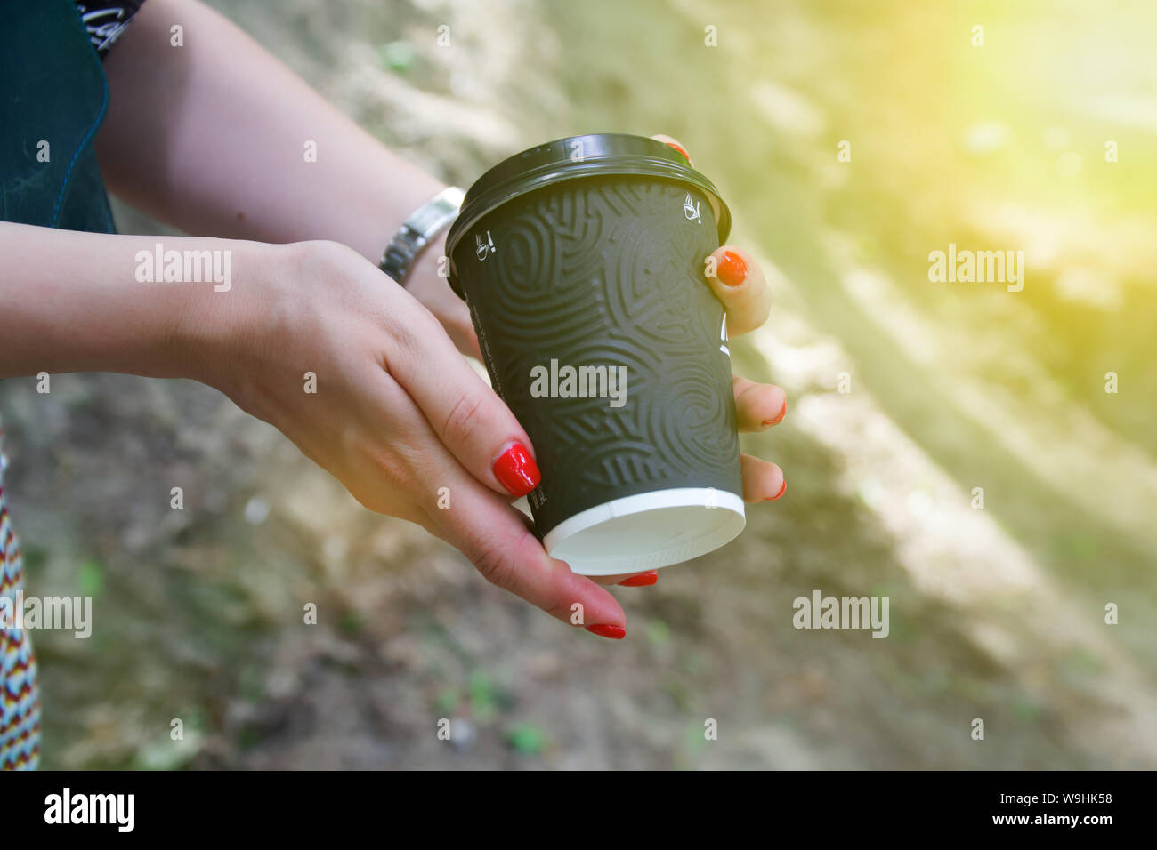 Female hand with black paper cup of coffee take away Stock Photo - Alamy