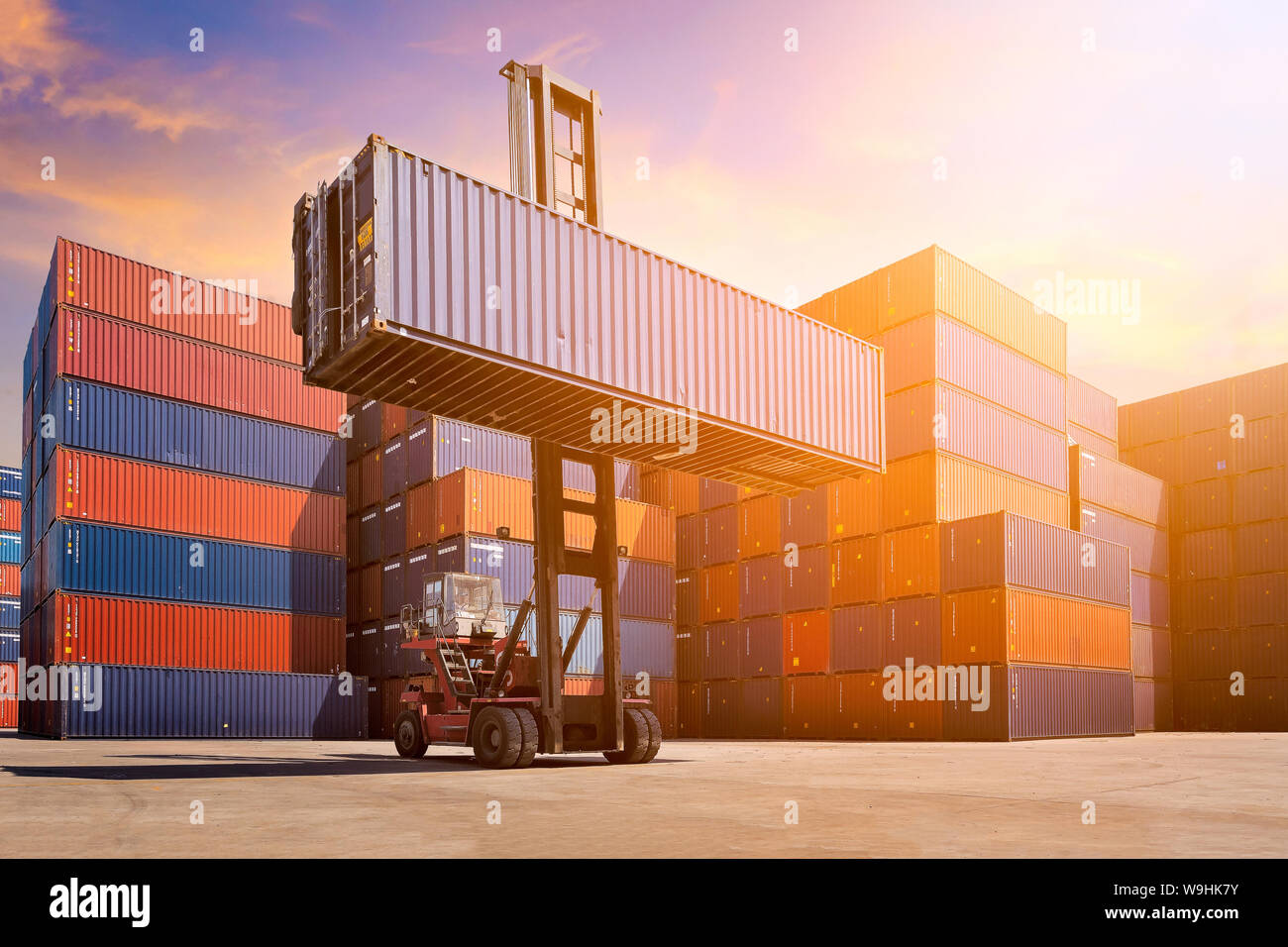 Logistic cargo container in shipping yard with cargo container stack in ...