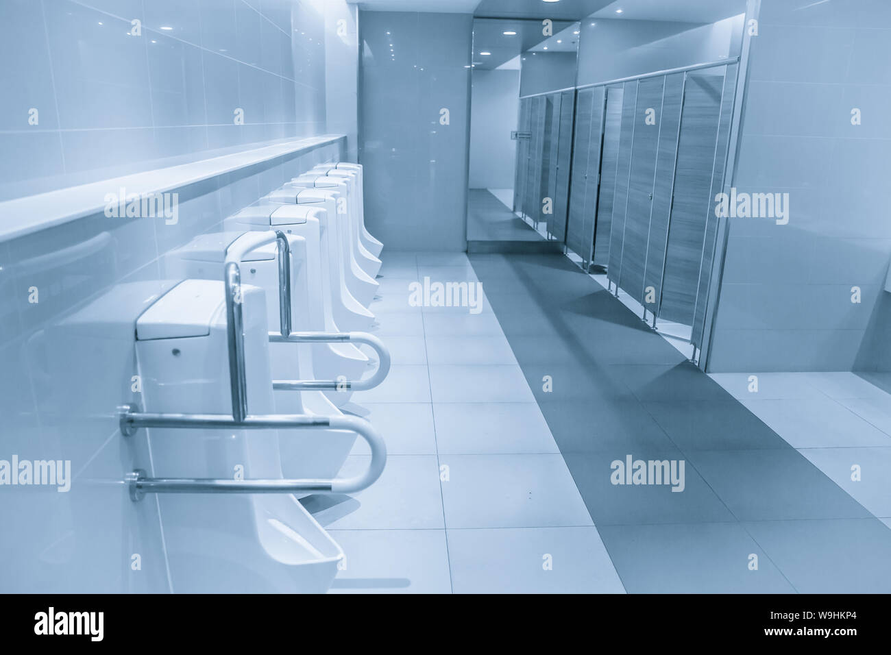 men toilet - clean urinals in a public restroom blue colour tone Stock ...
