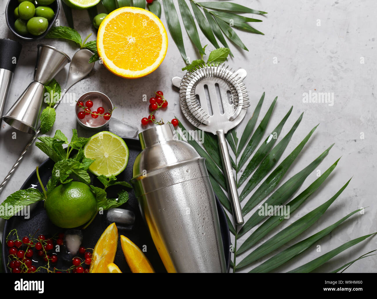 cocktail shaker on the background of fruits and tropical leaves Stock ...