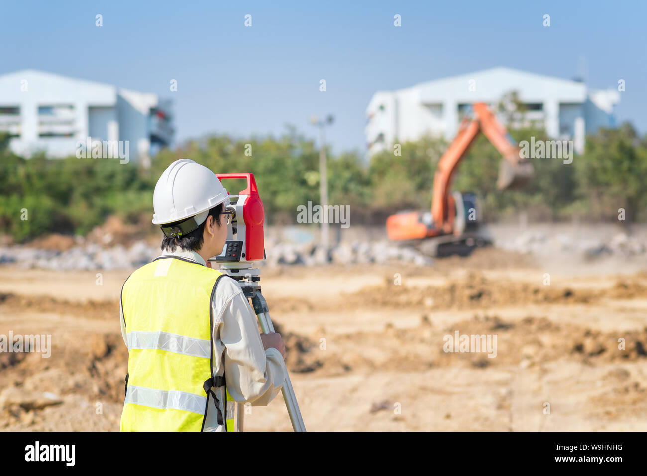 Construction engineer use surveyor equipment checking construction site ...