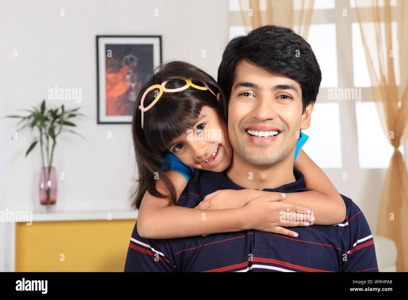 Girl hugging her father from behind Stock Photo - Alamy