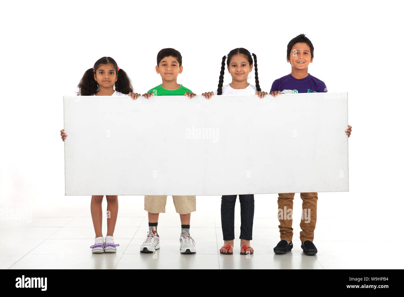 Group of children showing a placard and smiling Stock Photo - Alamy