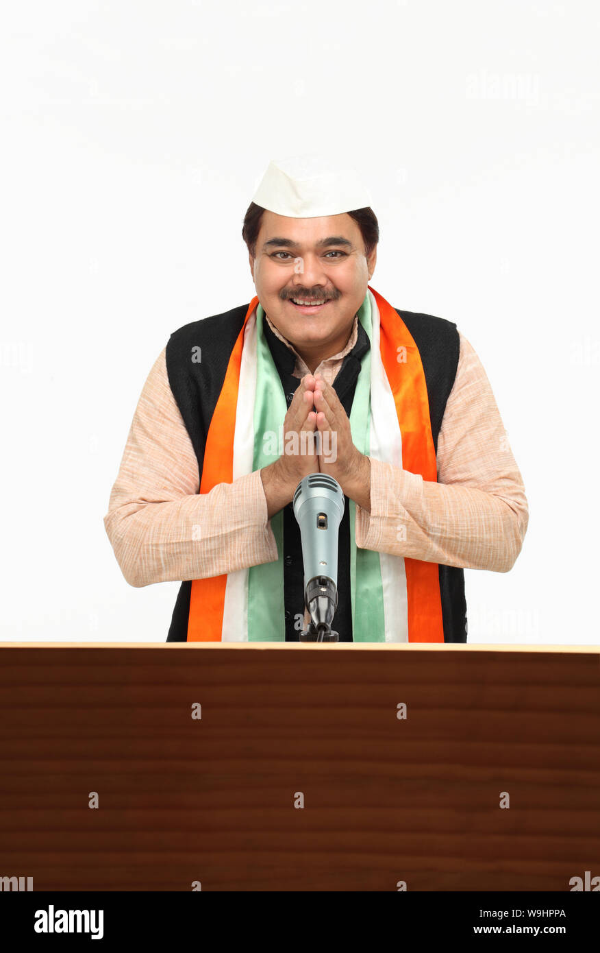 Politician welcoming with hands joined Stock Photo - Alamy