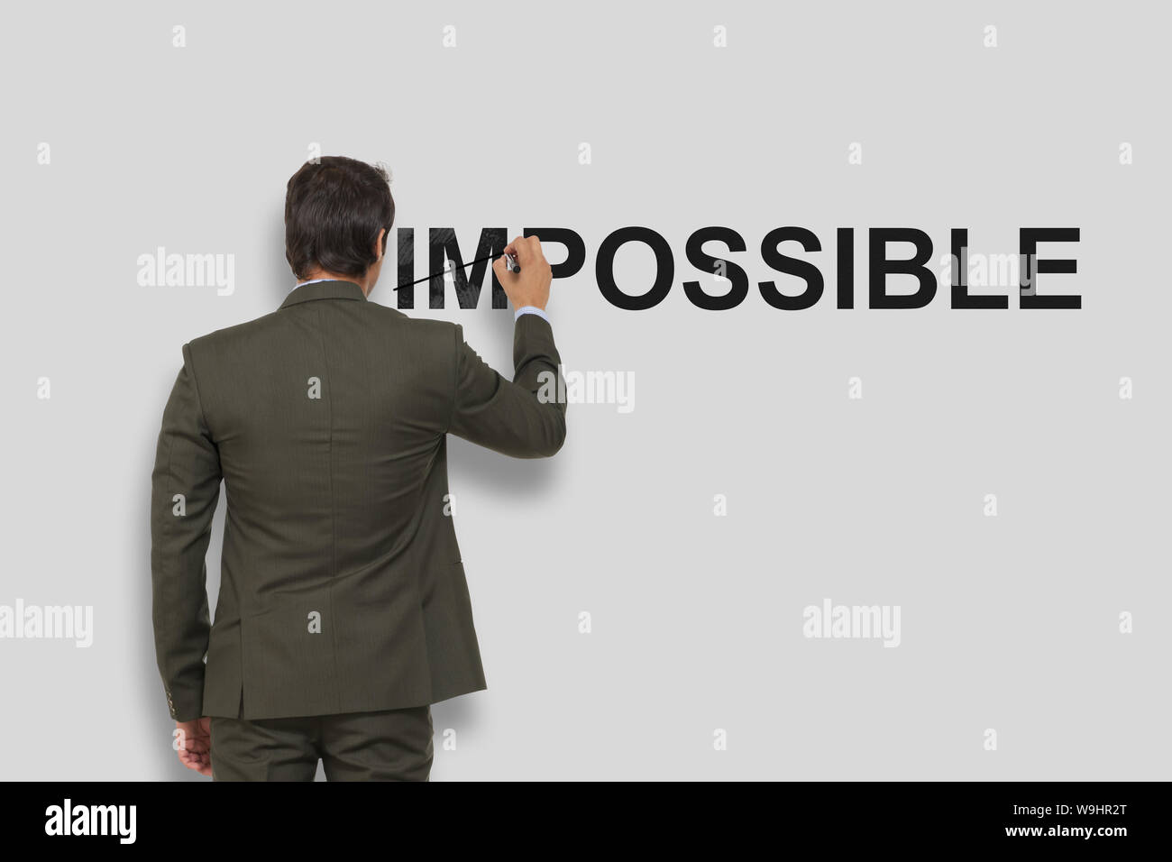Businessman transforming the impossible to possible Stock Photo - Alamy