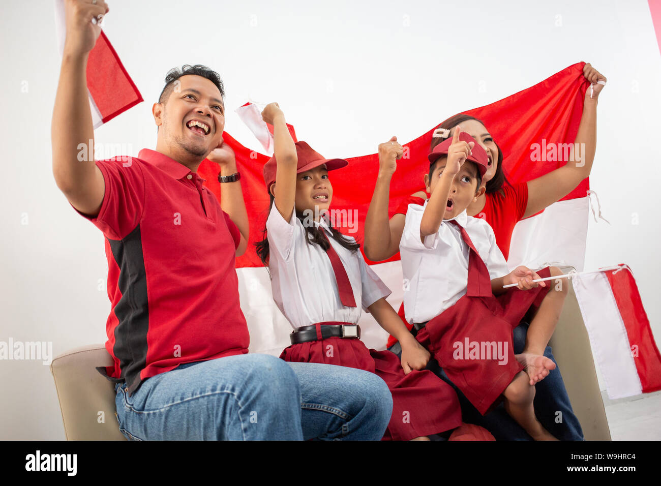 indonesian family holding indonesia flag over white background Stock ...