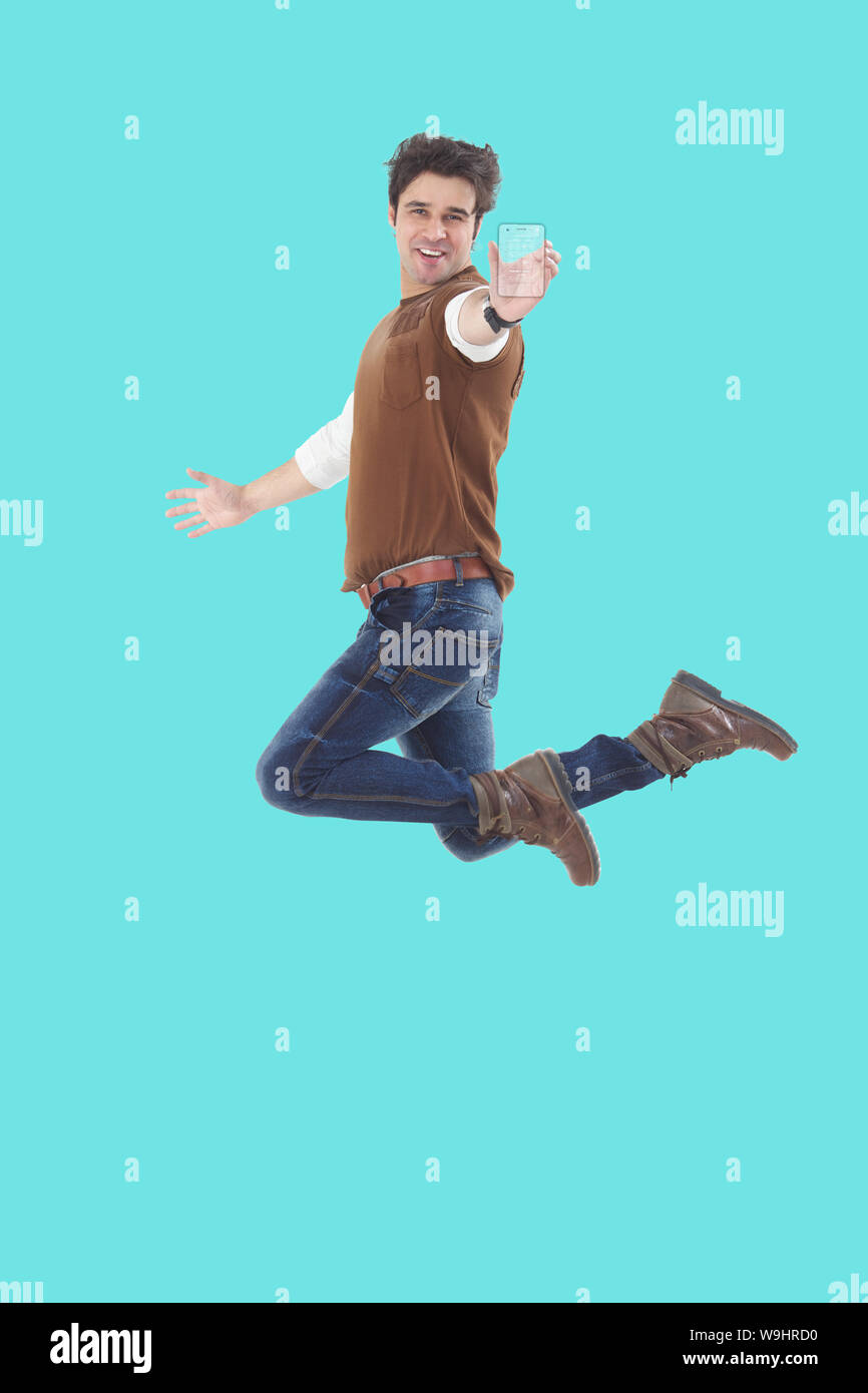 Young man jumping mobile phone hi-res stock photography and images - Alamy