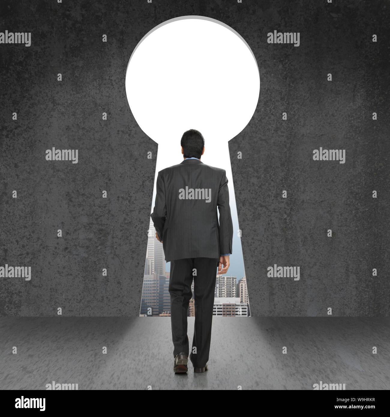 Businessman walking to opened concrete wall in form of a keyhole Stock ...