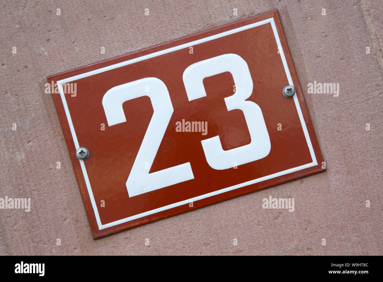 Red Number Twenty-Three on Stone Wall on Diagonal Tilt Stock Photo - Alamy
