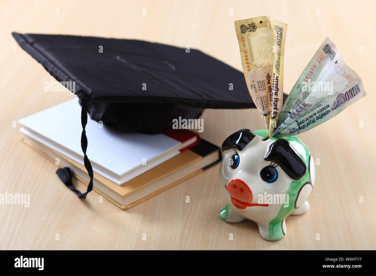 Graduation cap with piggy bank Stock Photo - Alamy