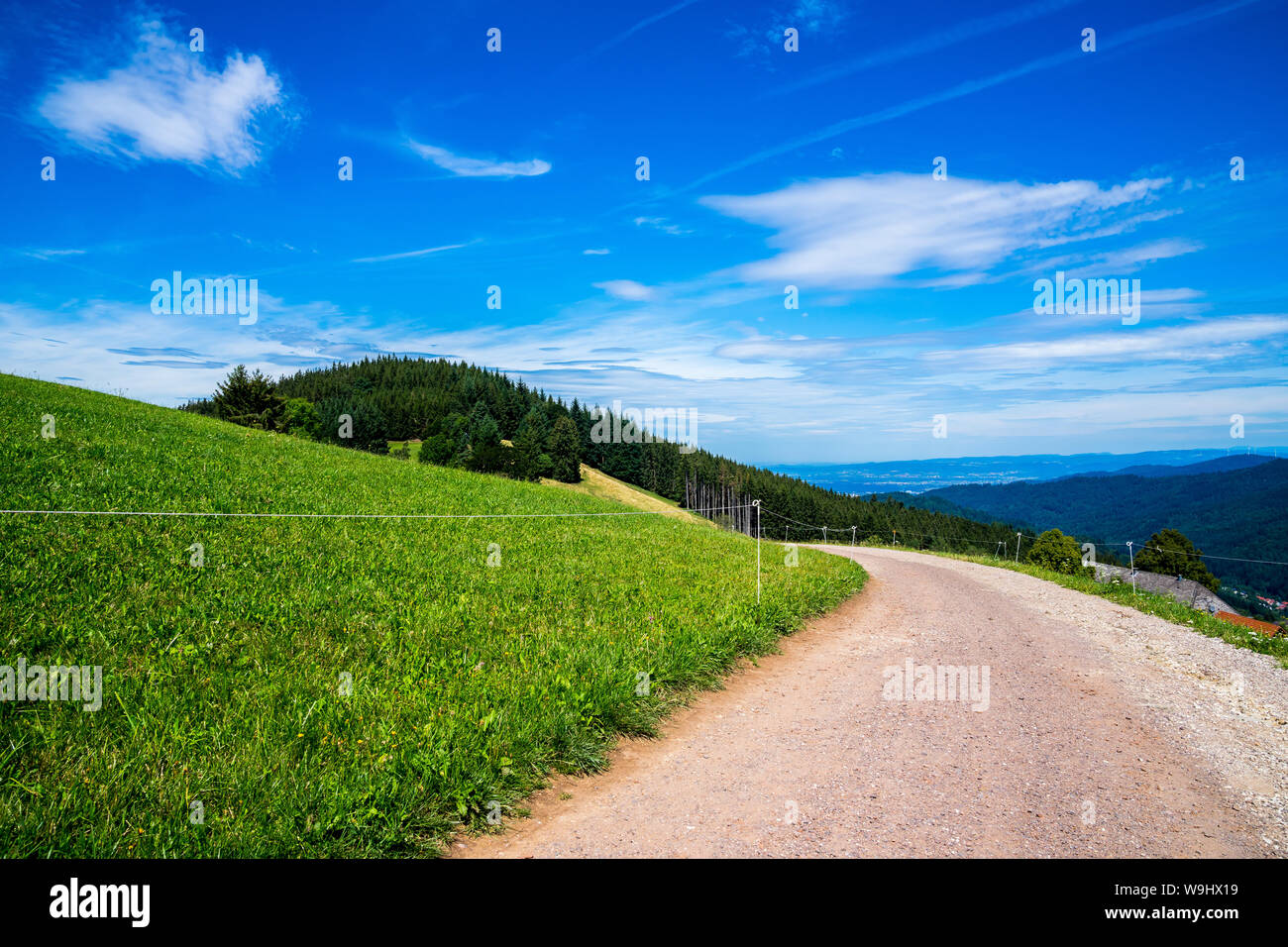 Germany, Hiking trail alongside green meadows with stunning views over ...