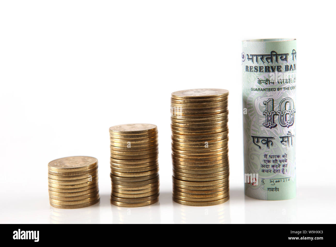 Stacks of Indian rupee coins and One hundred rupee banknote arranged in ...