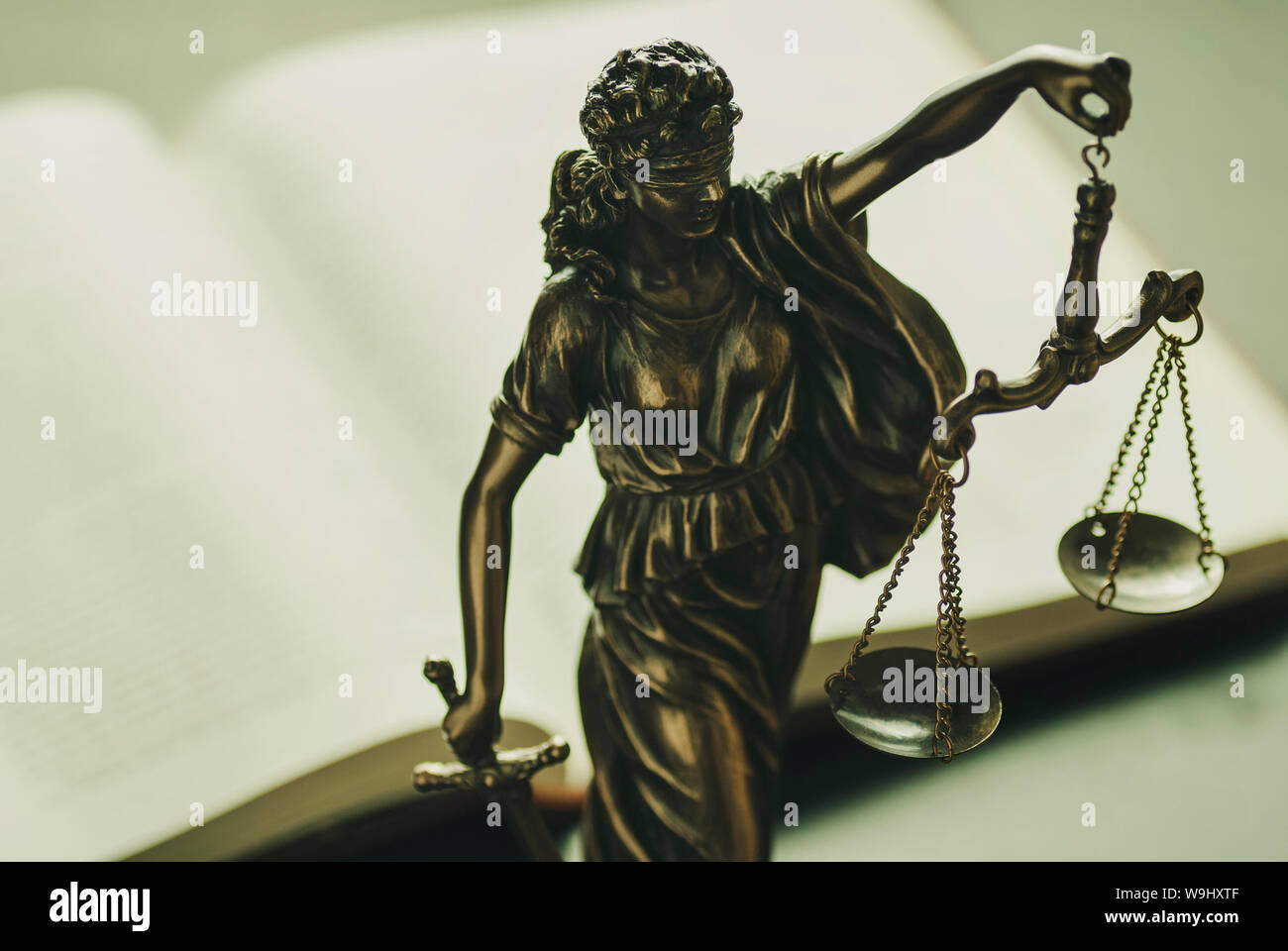 Brass statue of Justice with scales and sword symbolic of law and order ...
