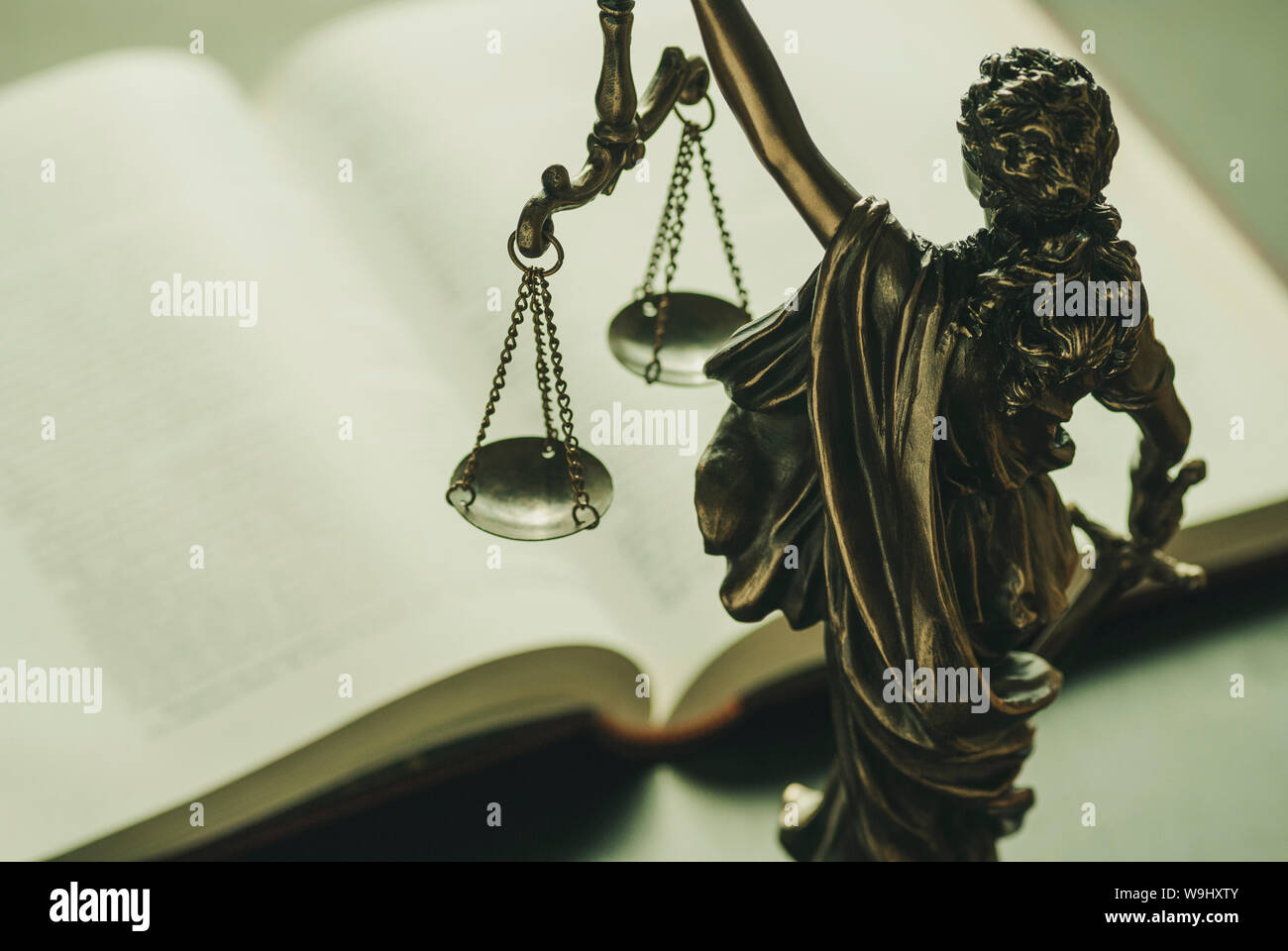 Figure of Justice holding up the scales of justice in her hand and ...