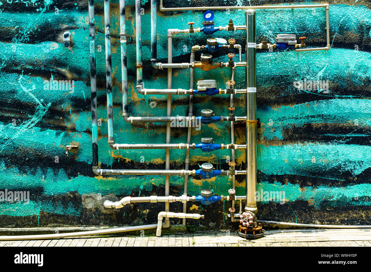 Rows of industrial water meters against colorful wall backdrop in OCT ...