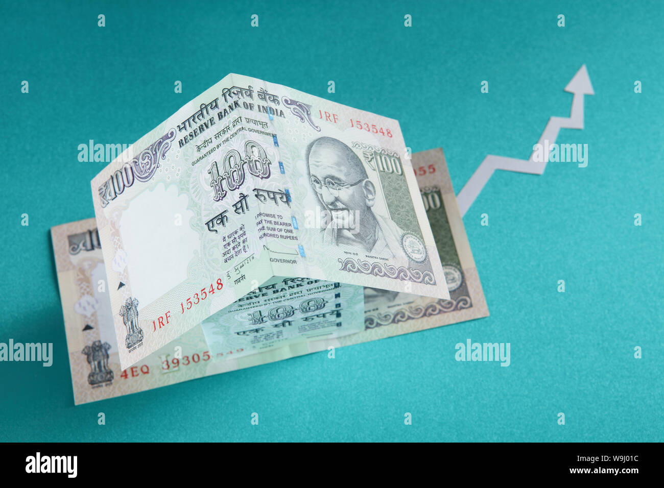 Model home made of one hundred rupee notes and representing hike in ...