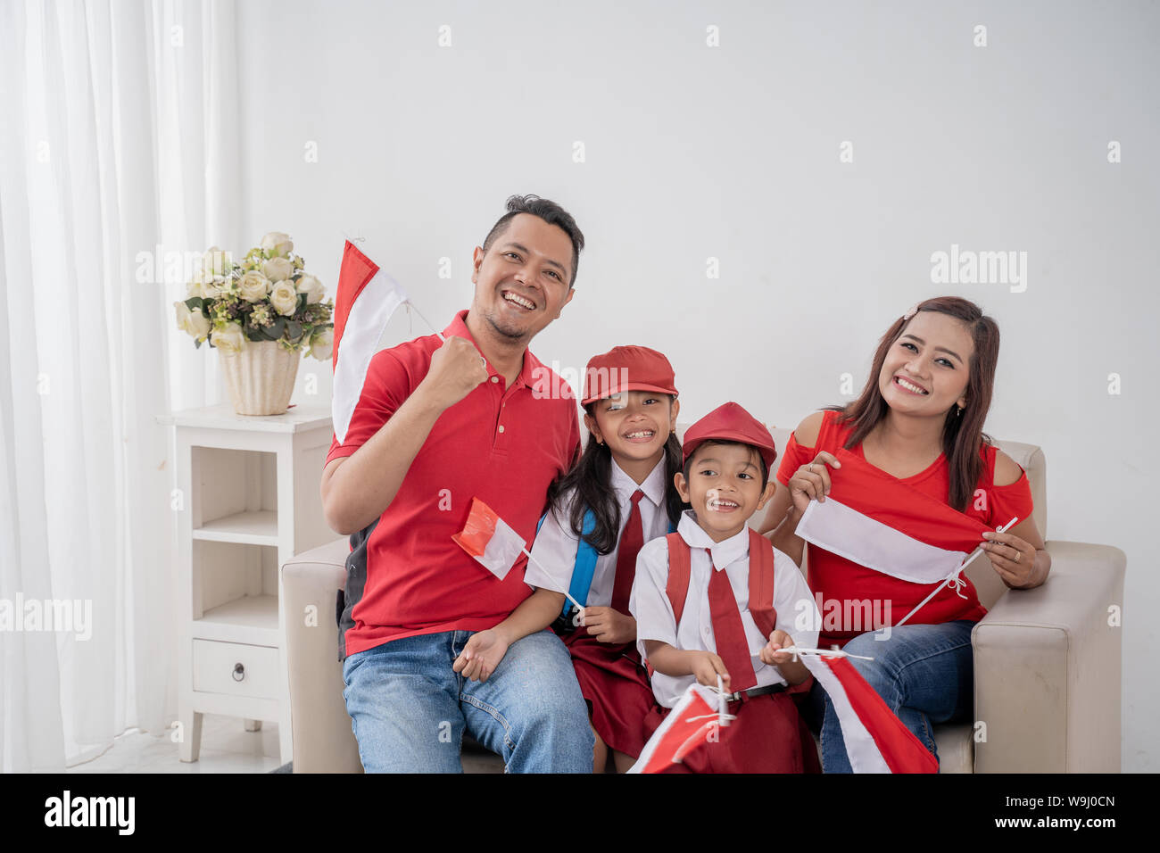 indonesian family holding indonesia flag over white background Stock ...