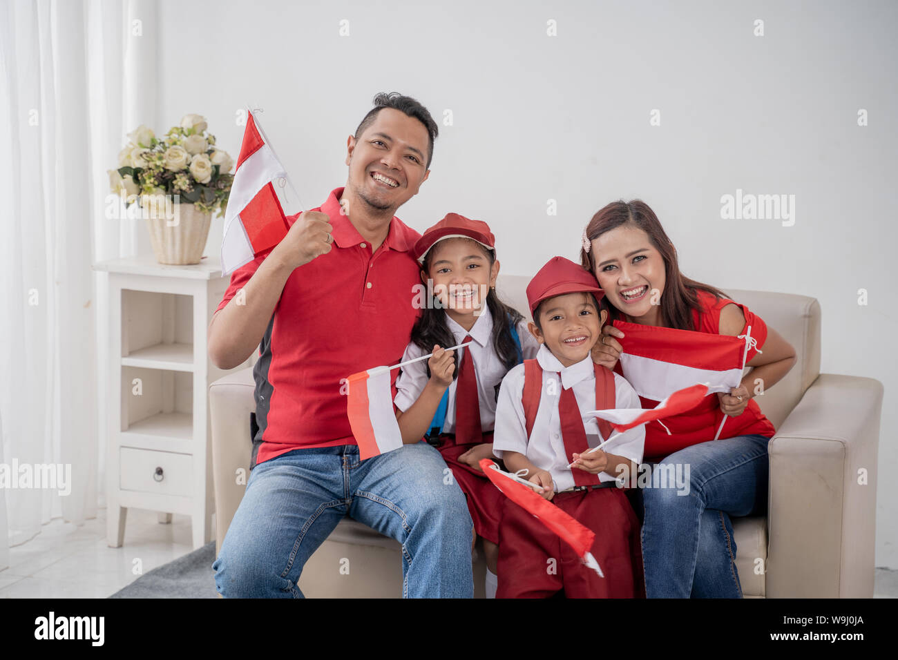 indonesian family holding indonesia flag over white background Stock ...