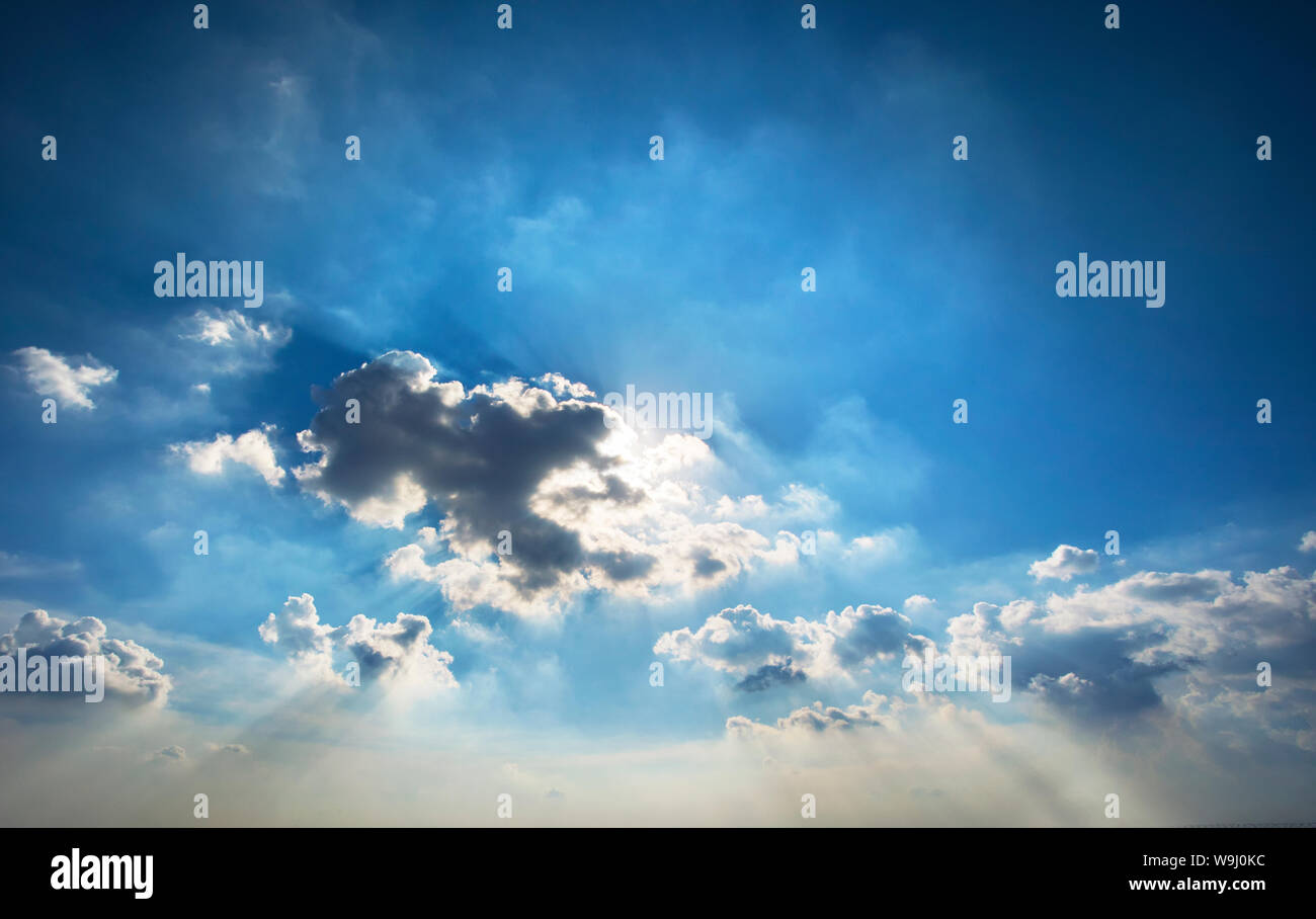 beautiful sun light through dramatic cloud against blue sky Stock Photo ...