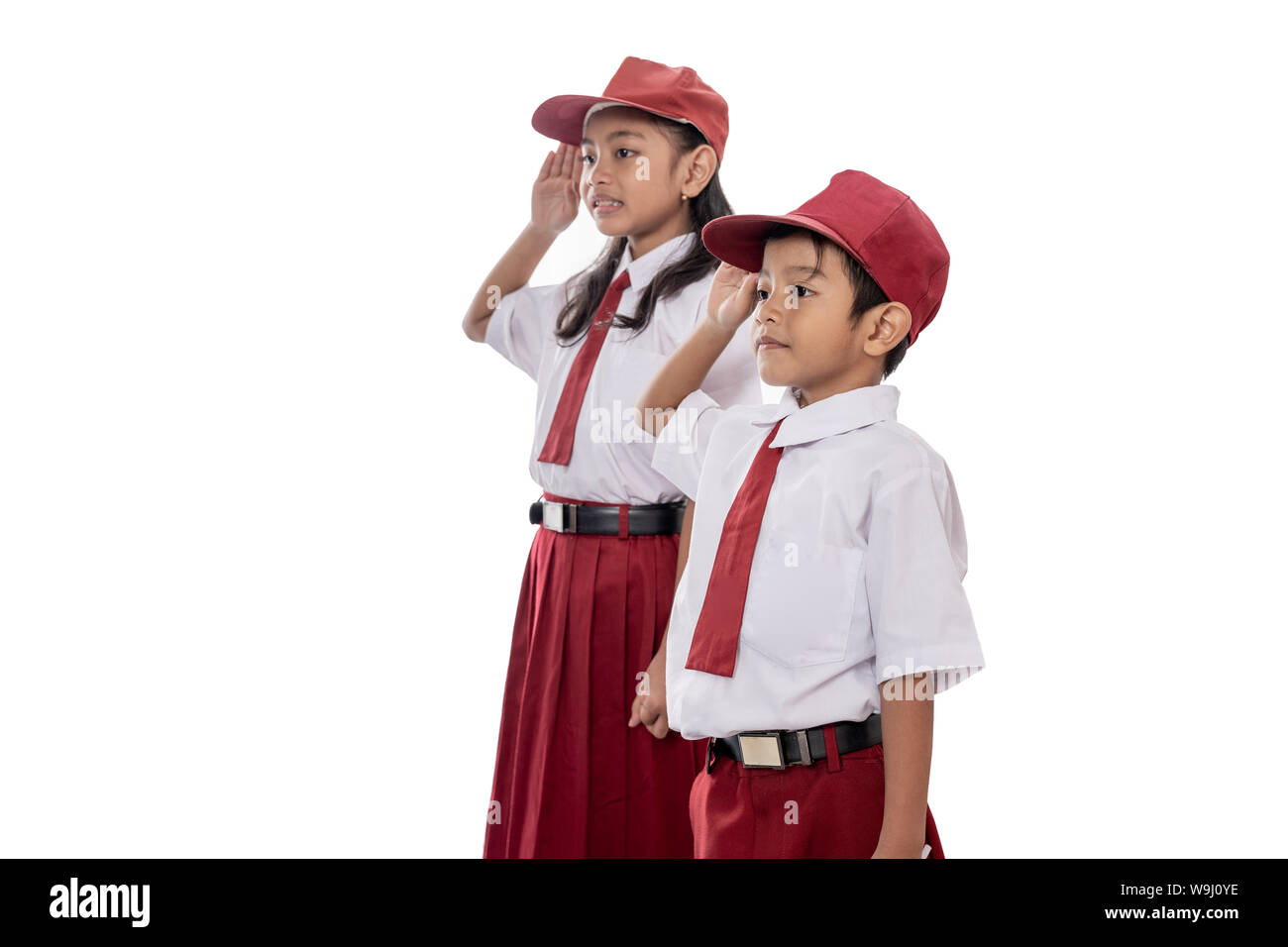 elementary student wearing uniform giving salute to indonesia flag ...