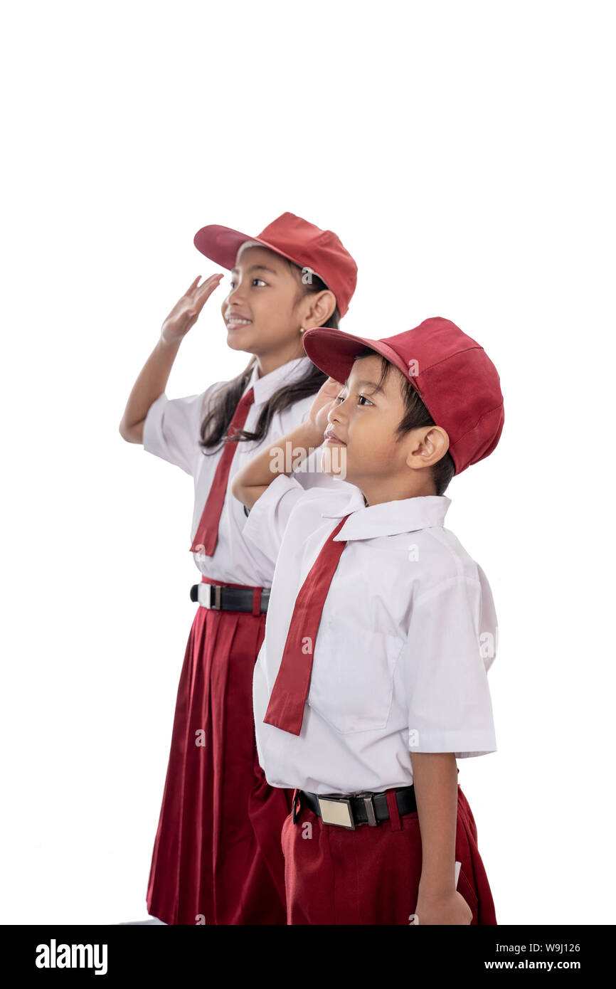 elementary student wearing uniform giving salute to indonesia flag ...